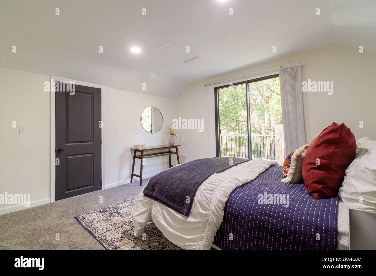 An interior of a newly renovated bedroom with a big window and a double ...