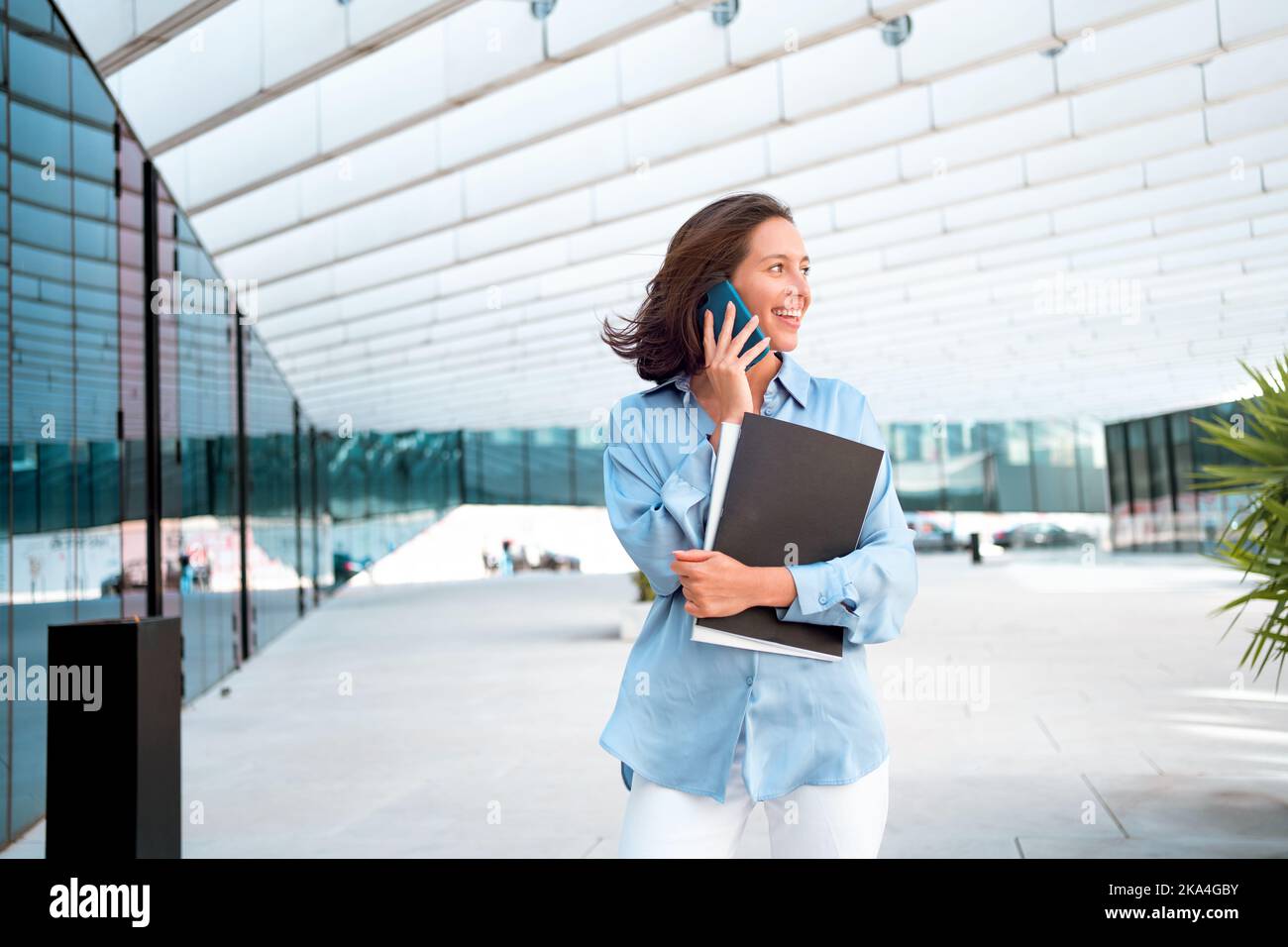 Excited caucasian businesswoman standing near office building have ...