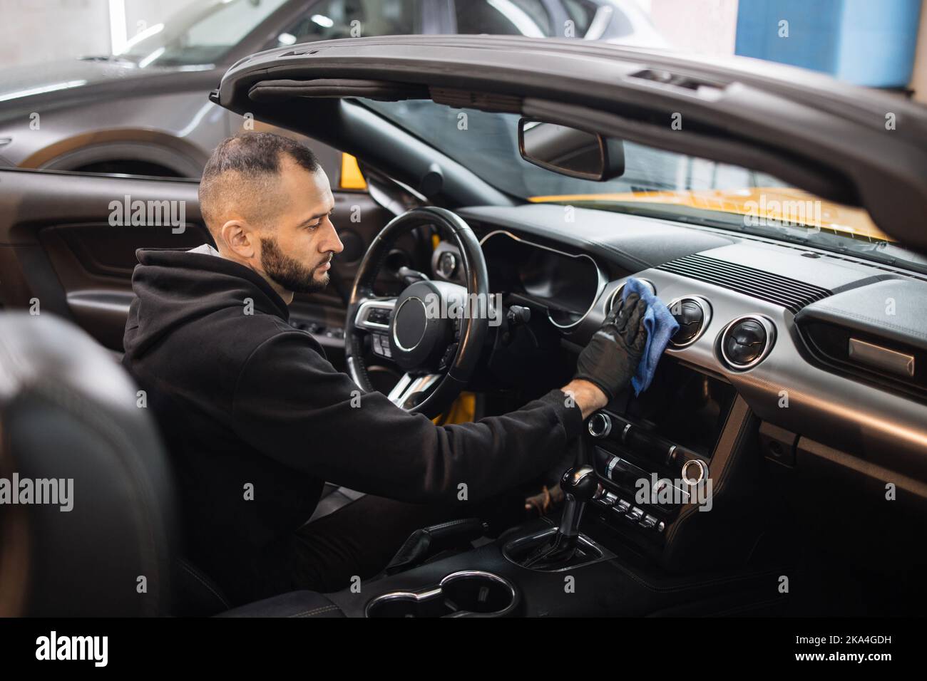 Cleaning service, car detailing concept. Young man, auto service worker ...