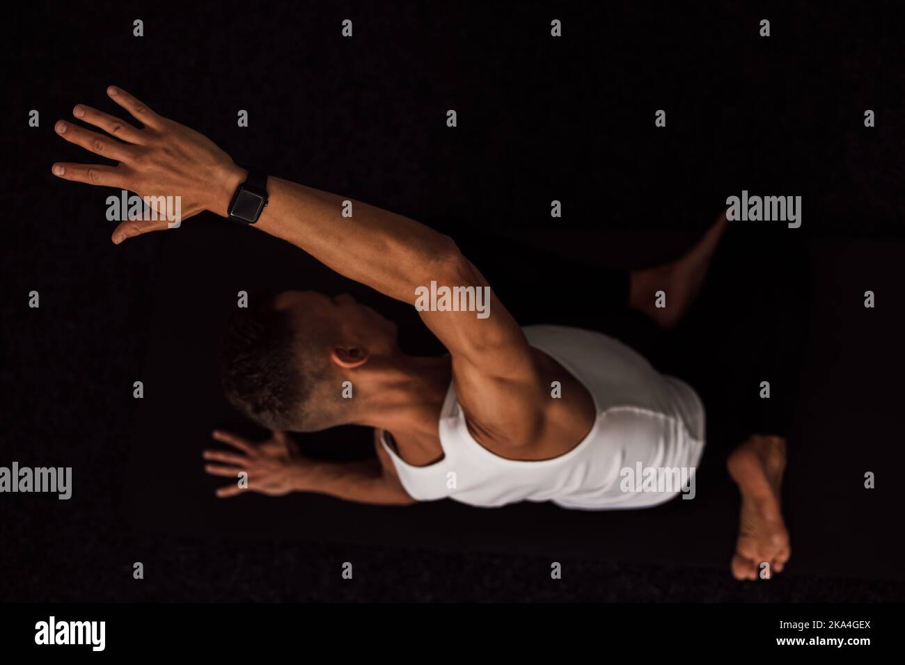 A man holds his knees with his hands doing yoga. Top view Stock Photo ...