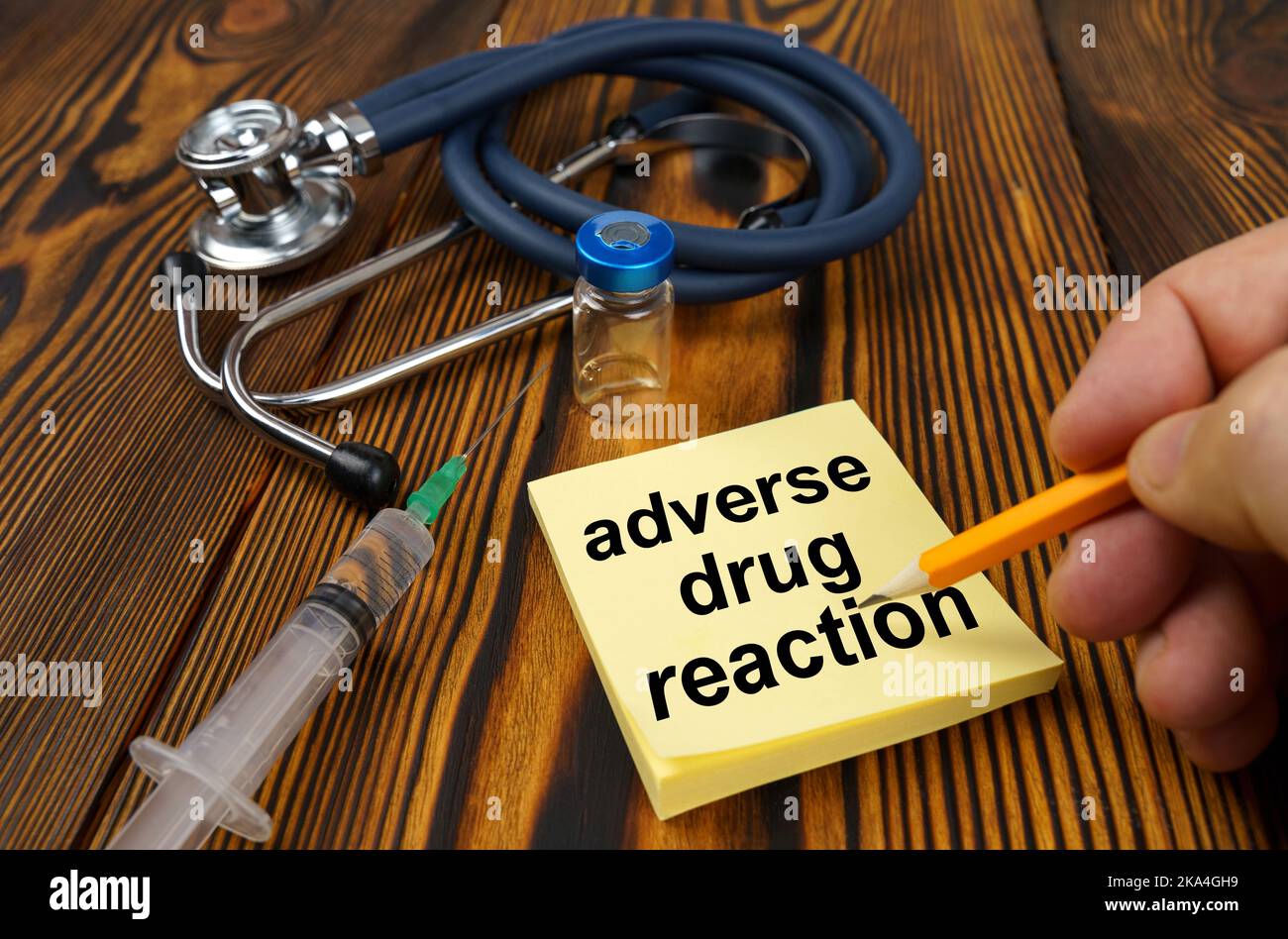 Medical concept. On the table is a stethoscope, a syringe, a man's hand ...