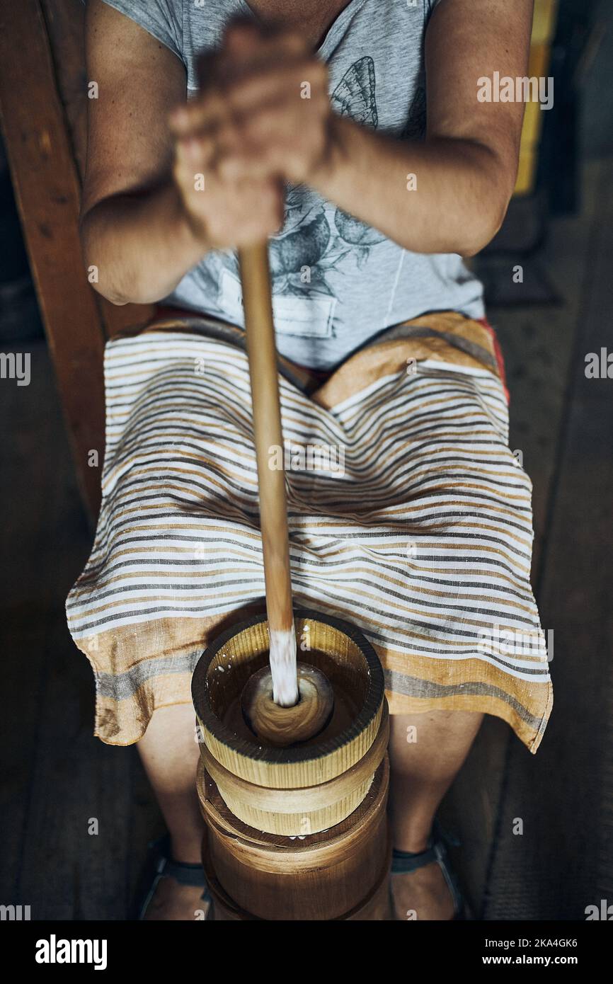 Woman making butter with butter churn. Old traditional method making of ...