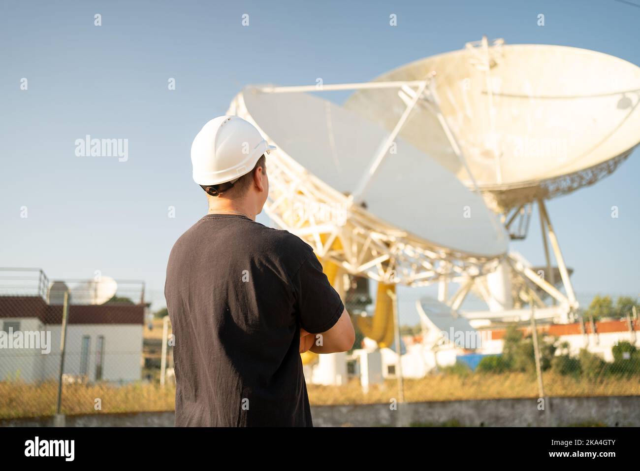 Engineer looking earth based astronomical radio telescope. Radio ...