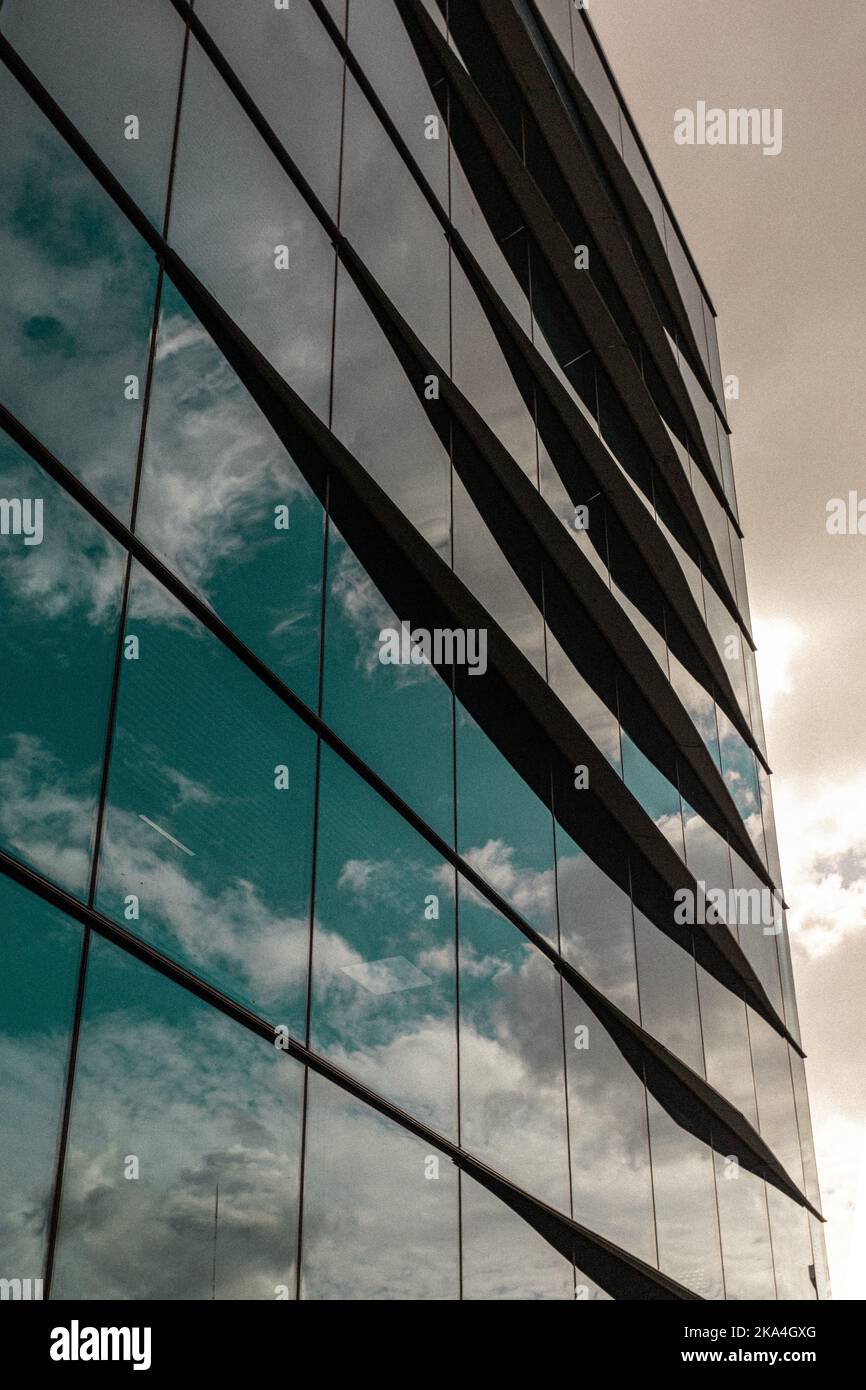 A vertical shot of the modern architecture of a building with glass ...