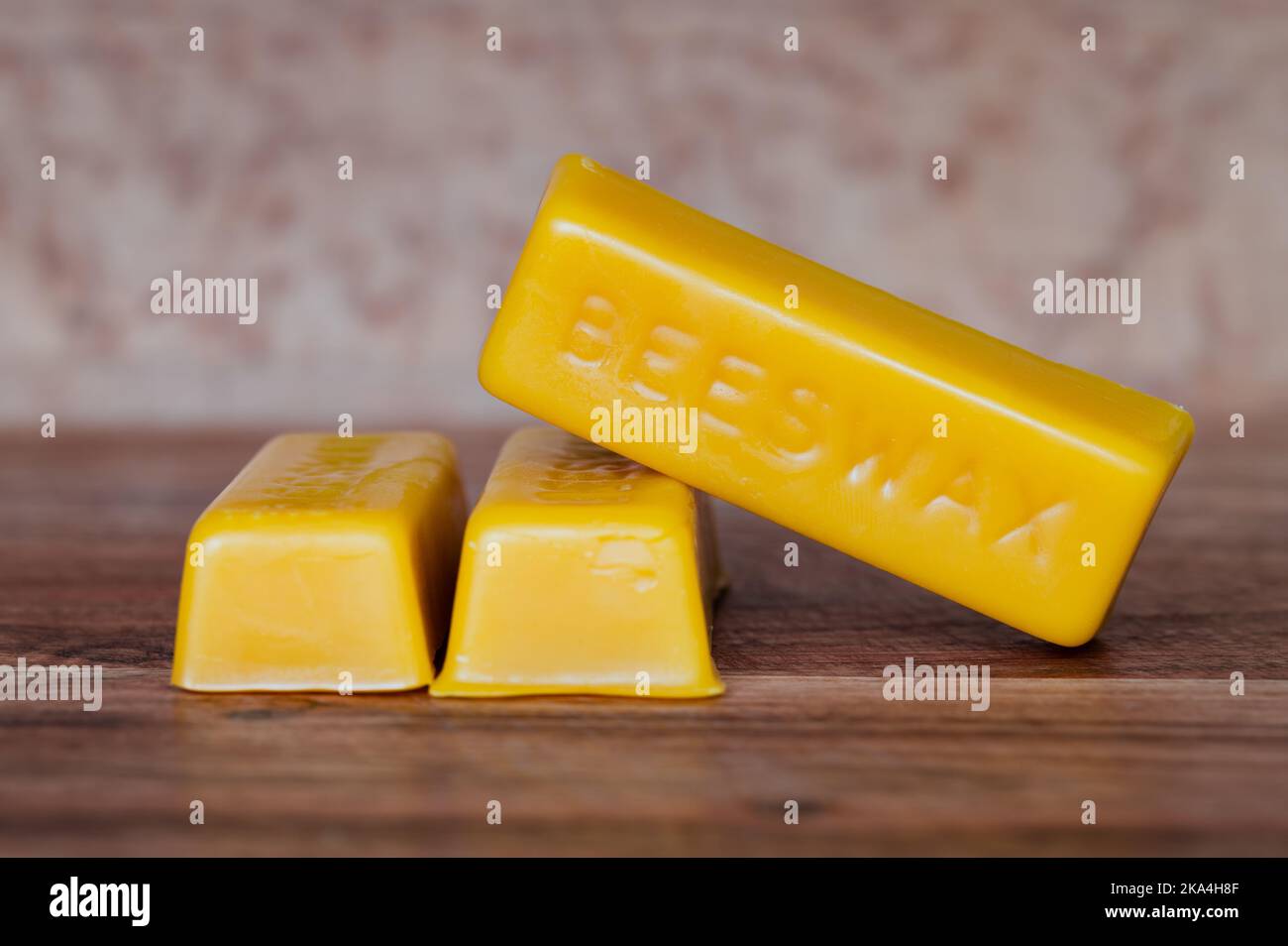 Three bars of pure beeswax on wood background Stock Photo - Alamy
