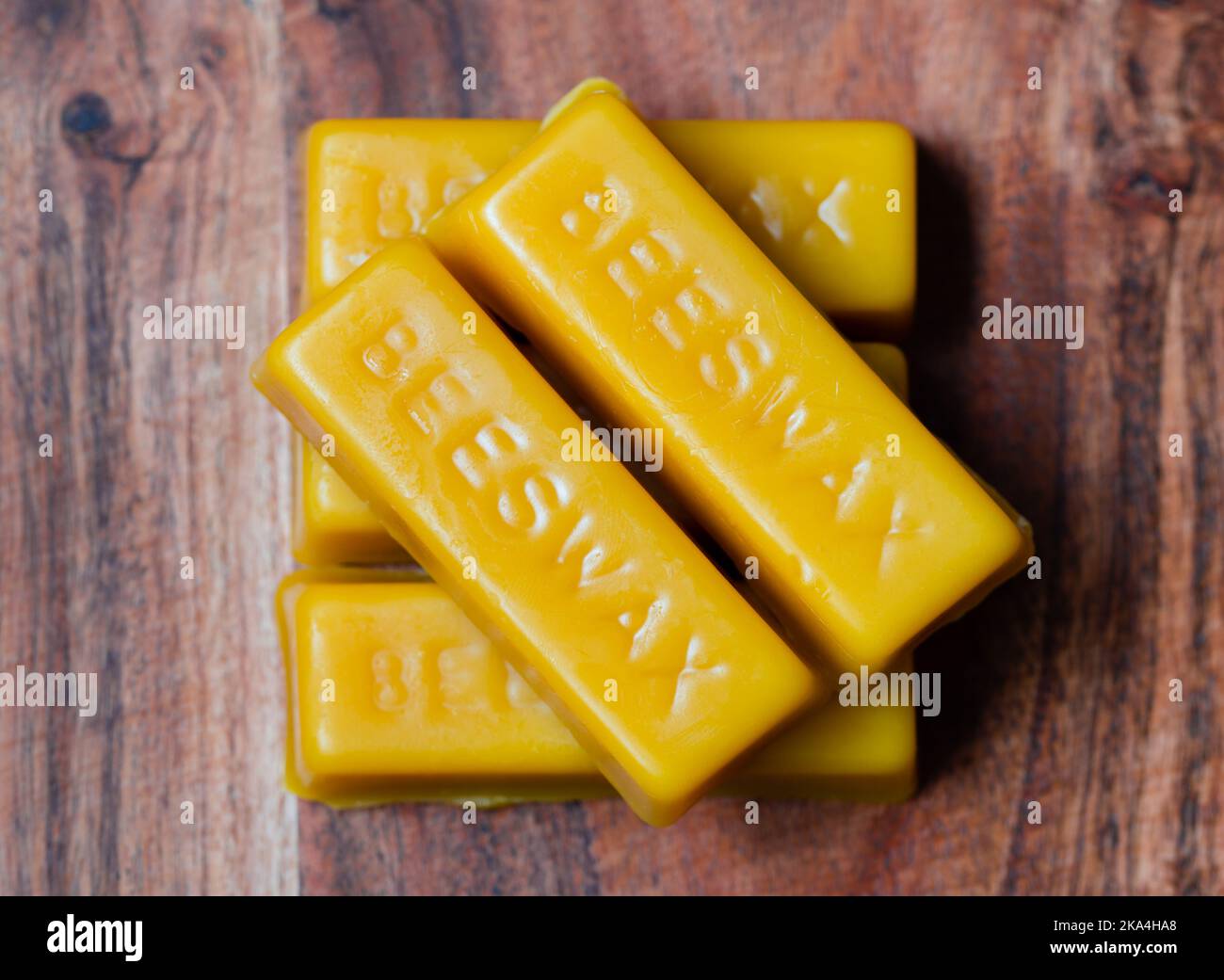 Top view of five pure beeswax bars on a wood background Stock Photo - Alamy