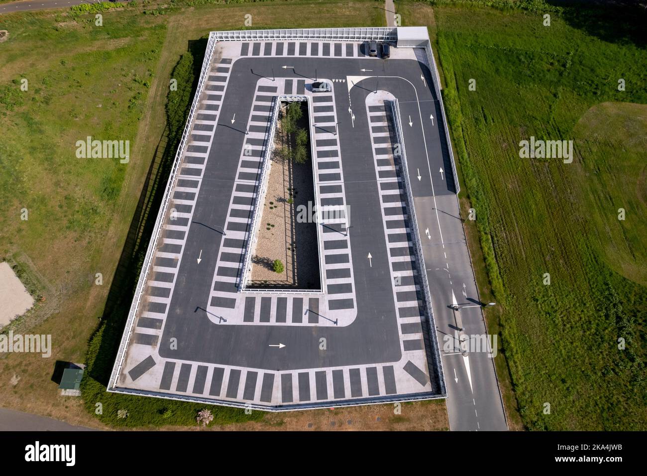Aerial overview of almost empty graphic outline parking lot with arrows ...
