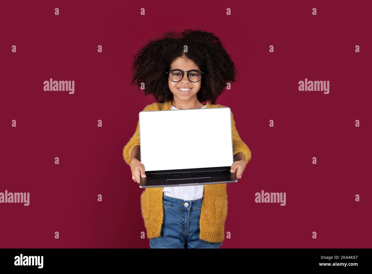 Cheerful black child holding laptop with white screen, mockup Stock ...