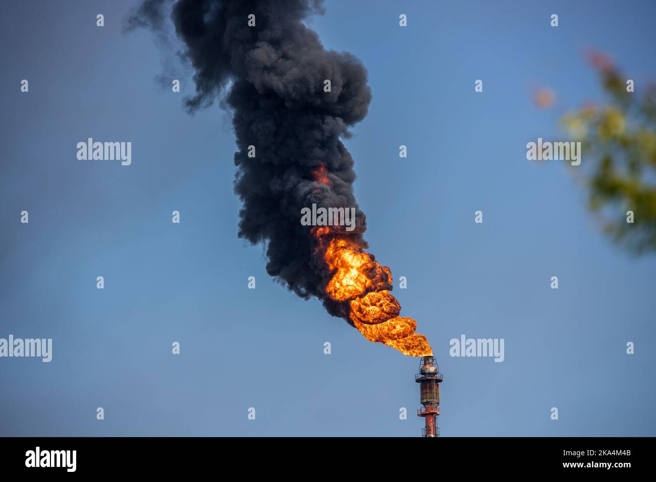 A power tower burning in the daytime Stock Photo - Alamy