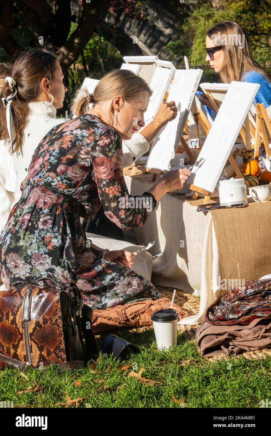 An adult painting workshop around the pond in Central Park offers a ...