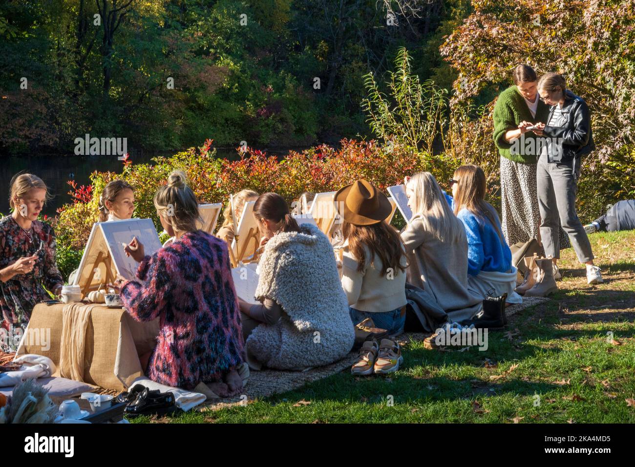 An adult painting workshop around the pond in Central Park offers a ...