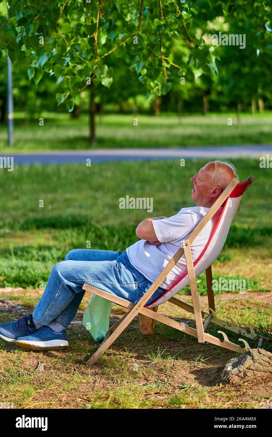 Old man sleeping on chair hi-res stock photography and images - Alamy