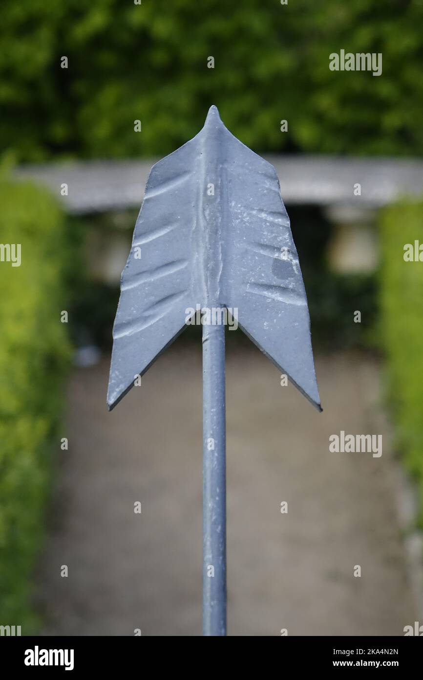 Metal arrow tip pointing forward in spring, concept: target, focus ...