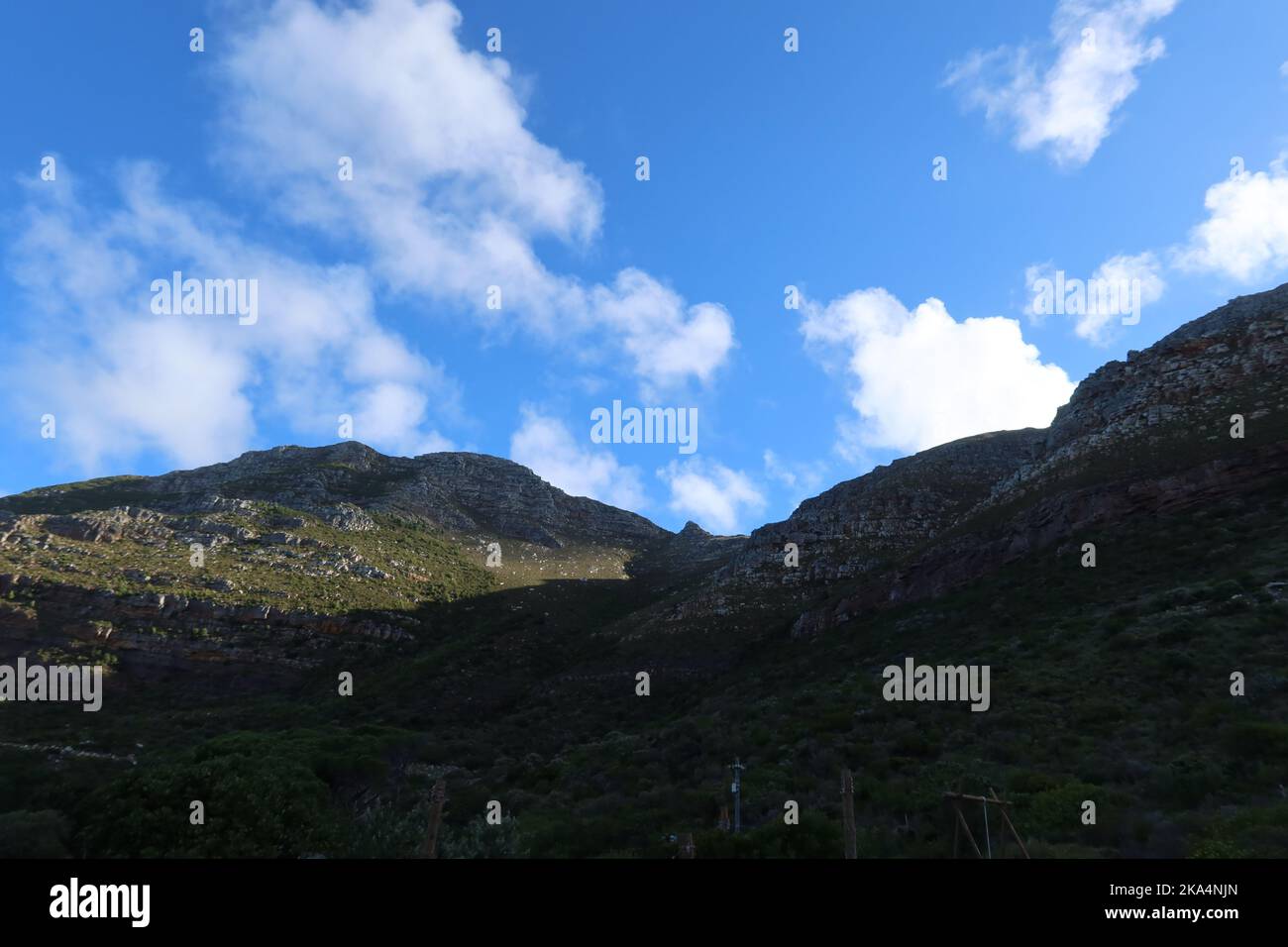 A beautiful scene of hills under a blue cloudy sky Stock Photo - Alamy