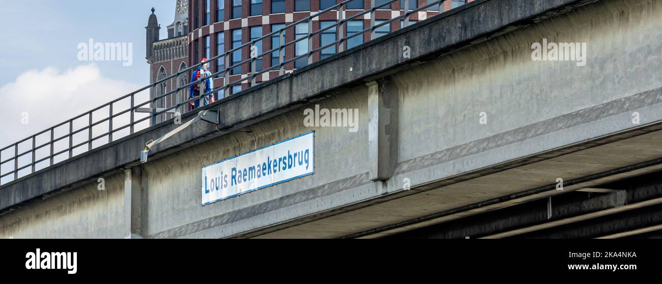 The Louis Raemaeker bridge with a sign, and the Natalini Tower in the ...