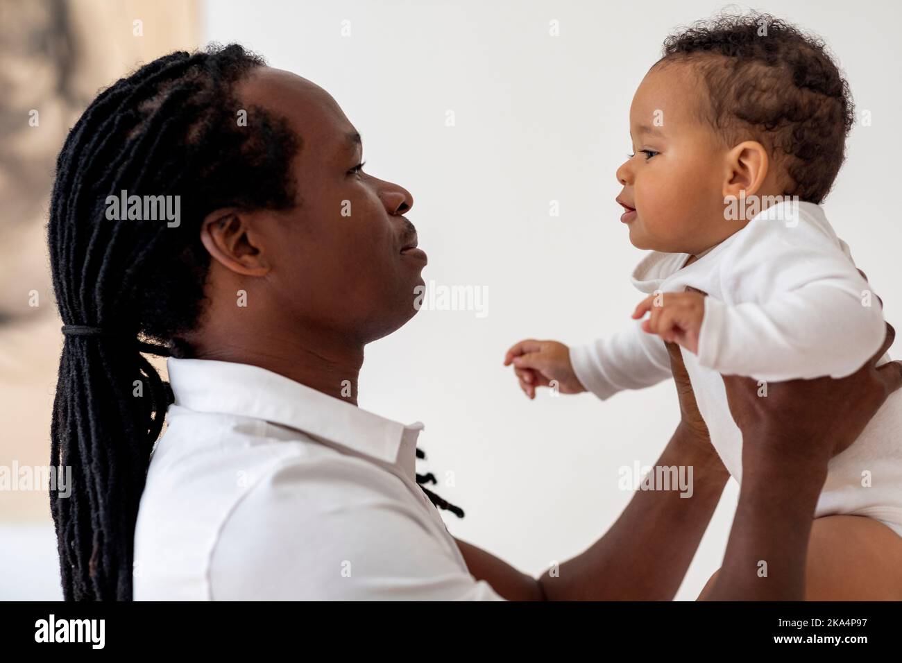 Father's Care. Young Black Dad Bonding With Cute Infant Baby At Home ...