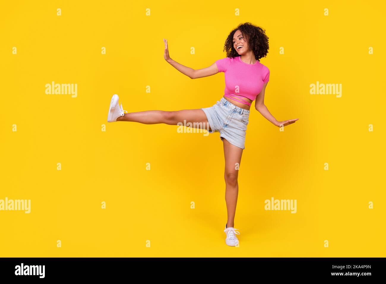 Full body photo of playful cheerful girl have fun raise one leg dancing ...