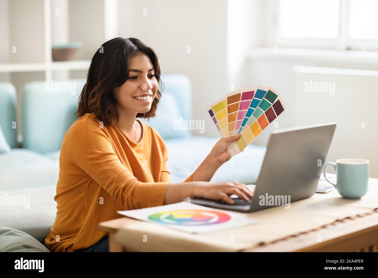 Arab Female Freelance Graphic Designer Working With Laptop And Color ...