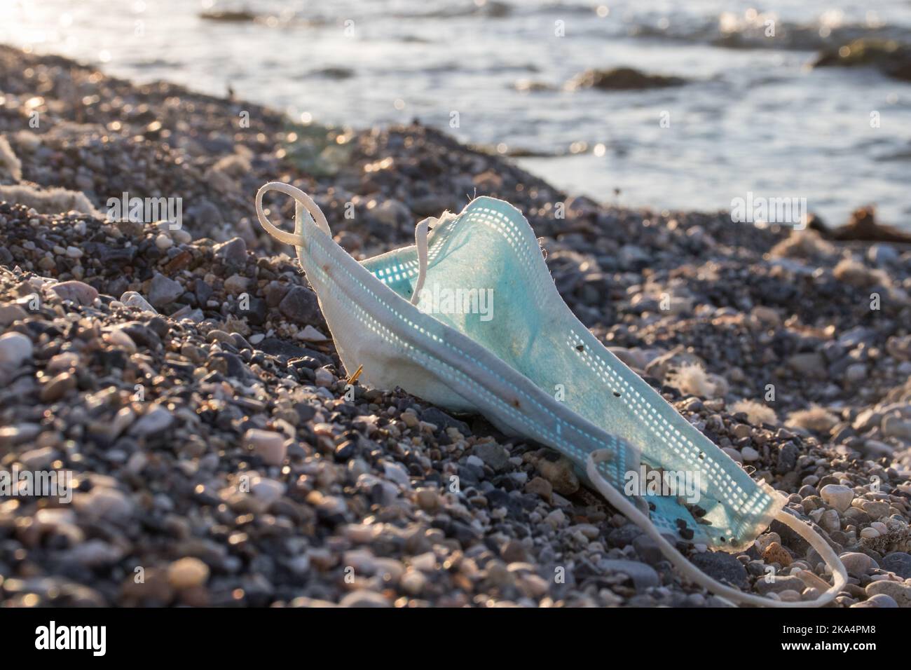 Discarded single -use face mask. Medical face mask on a beach Stock ...