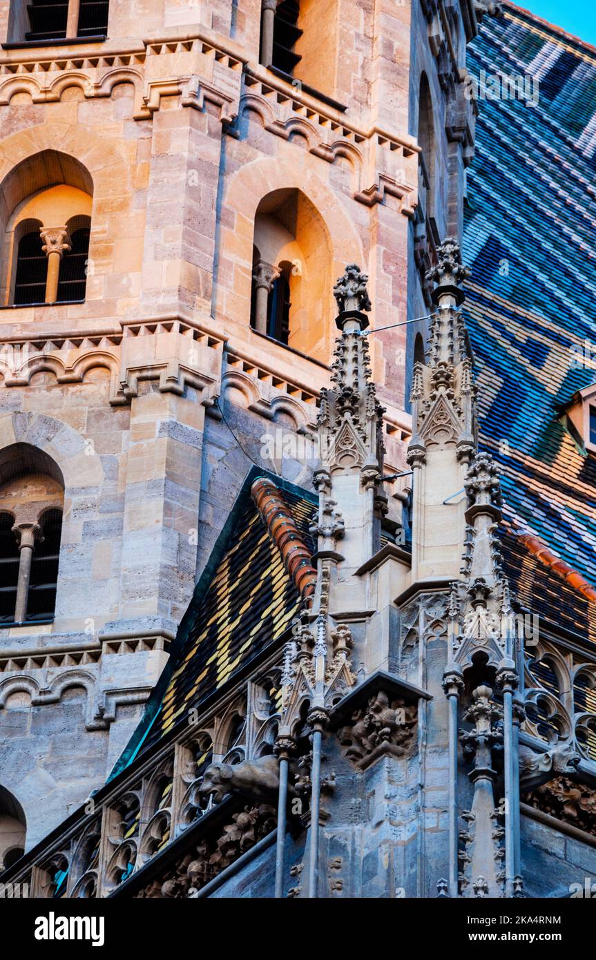 Gothic spires, Romanesque tower and colorful tiled roof of St. Stephen ...