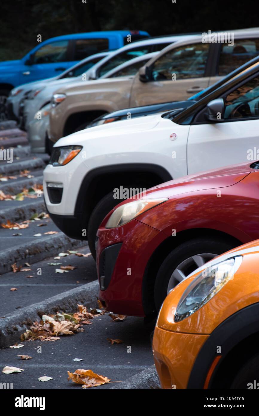 Row of cars with different colors and models, lined up at a parking lot ...
