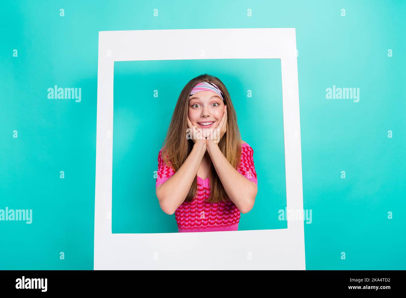 Photo of dreamy school girl dressed pink crop top arms hands cheeks ...