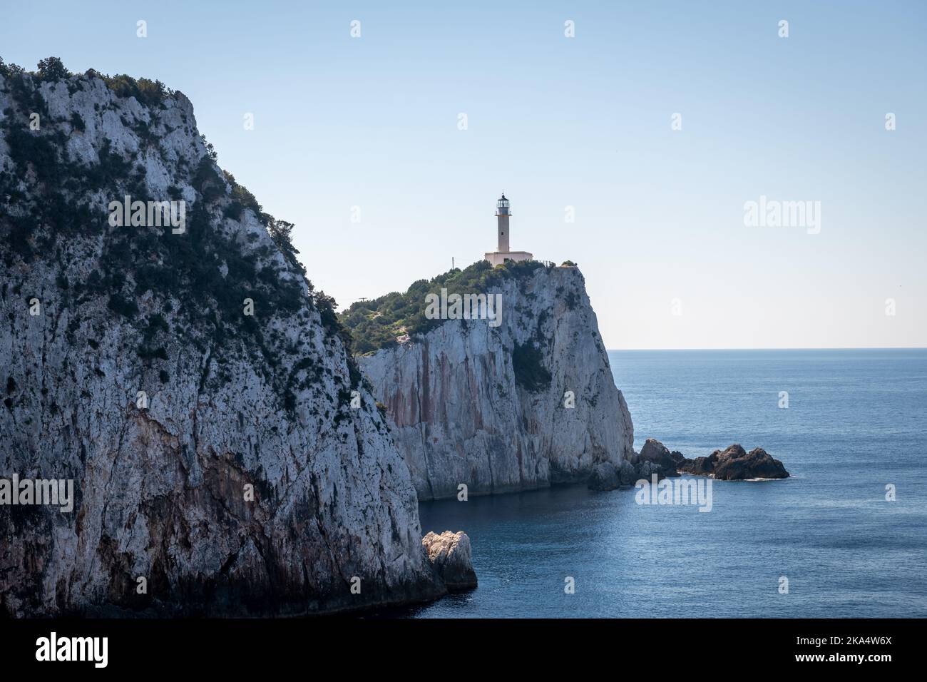 Distance view of a lighthouse built on a cliff top on the cape of an ...