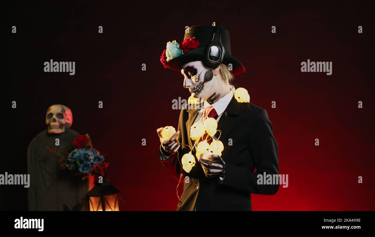 Creepy lady of death listening to music in studio, wearing halloween ...