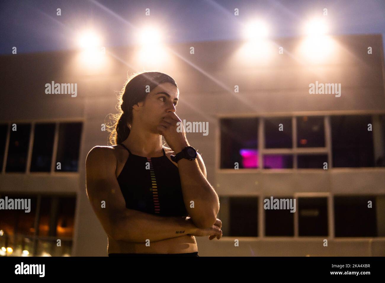 woman running on a running track at night Stock Photo - Alamy