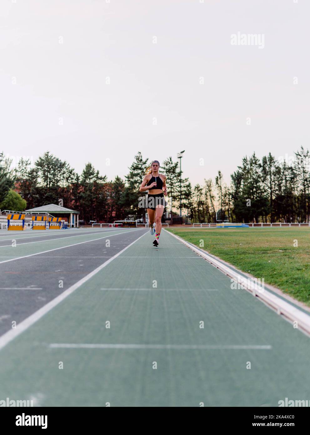 woman running on a running track Stock Photo - Alamy