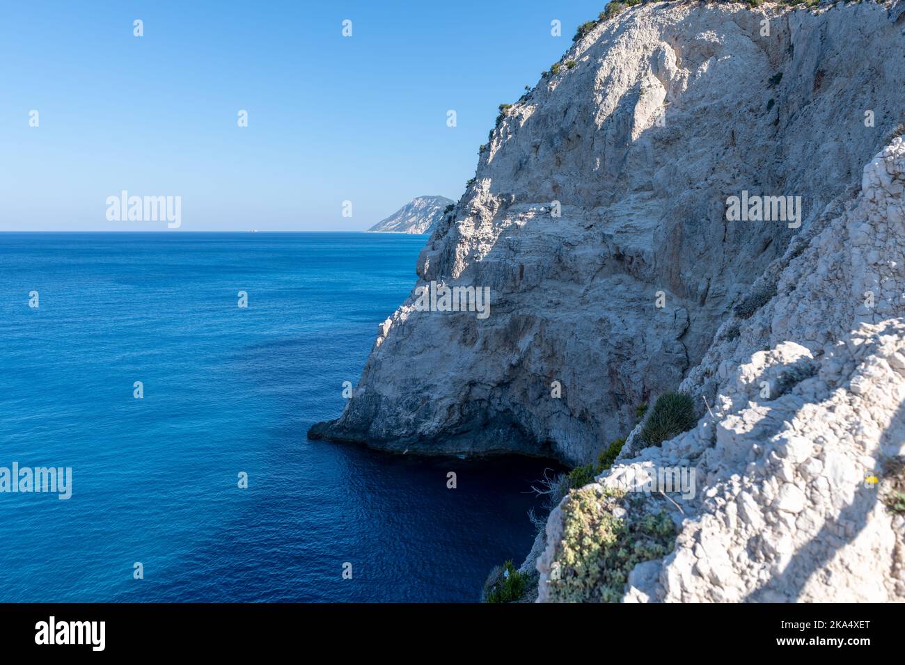 Dramatic cliffs dropping into deep blue sea Stock Photo - Alamy