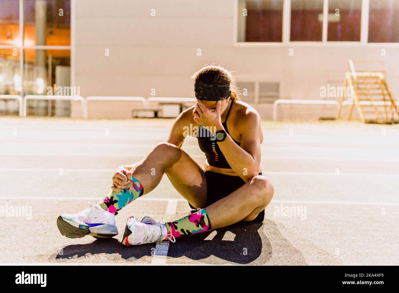 woman on a running track tired Stock Photo - Alamy