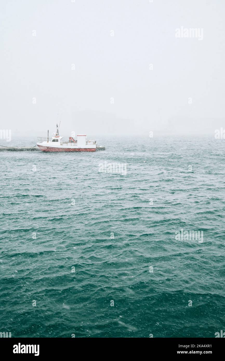 Boat floating on rippling sea Stock Photo - Alamy