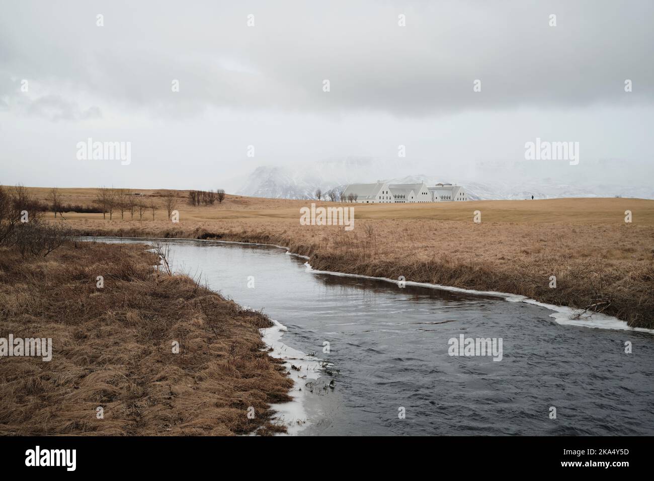 Shallow river flowing through dry countryside field Stock Photo - Alamy
