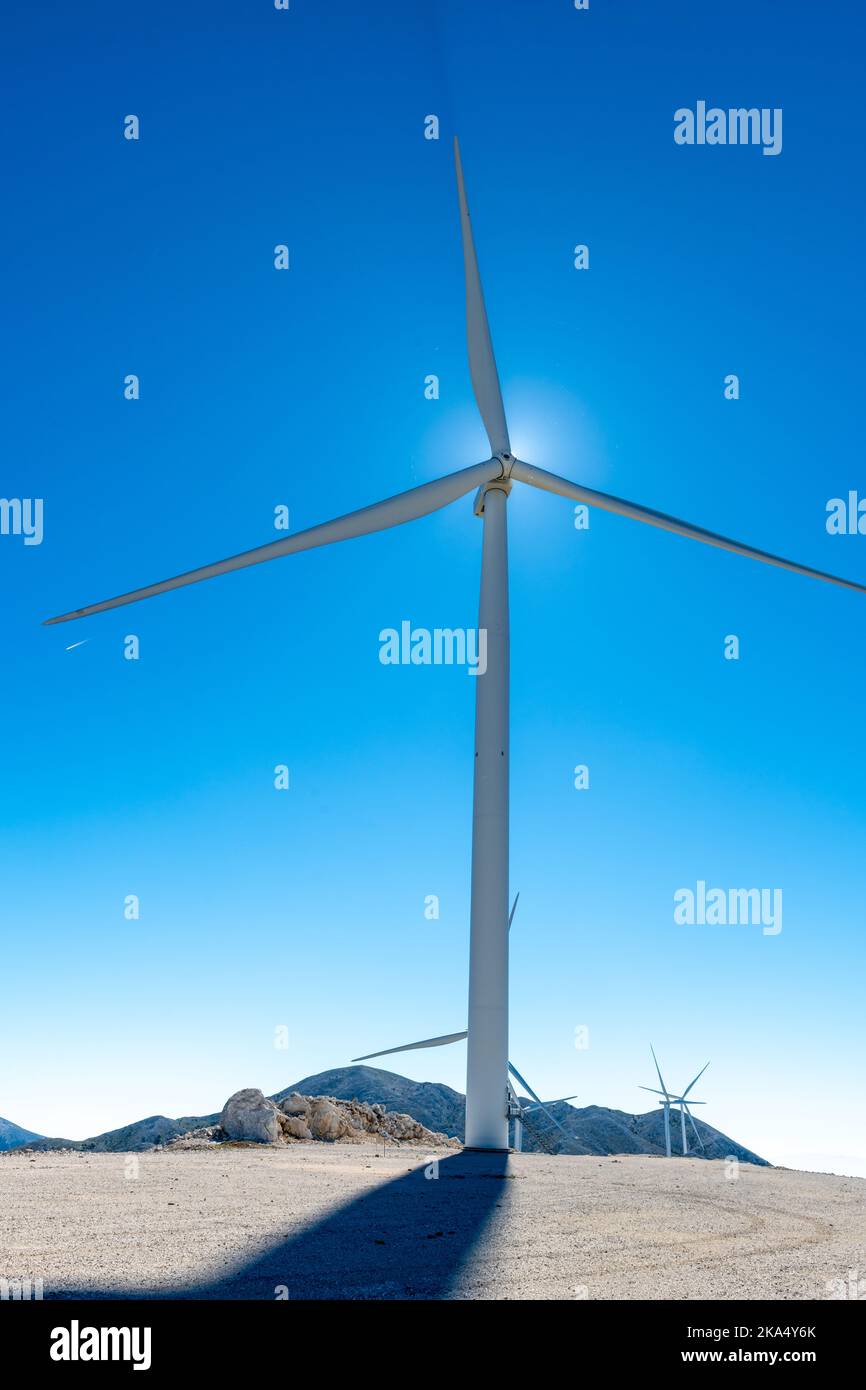 A wind turbine with the sun behind casting a heavy shadow Stock Photo ...