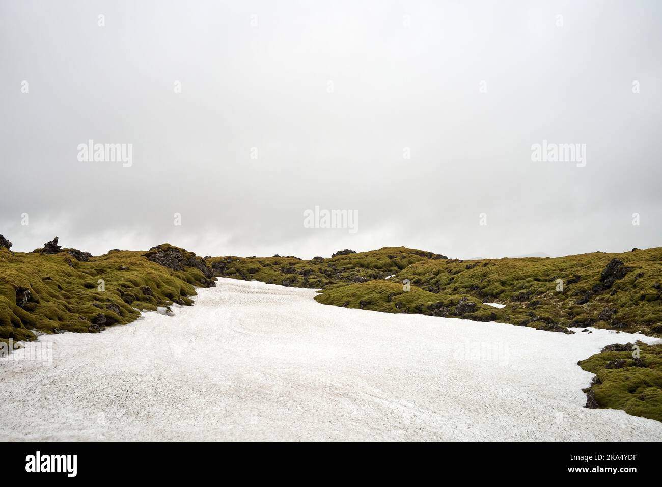 Rocks and snow against gray sky Stock Photo - Alamy
