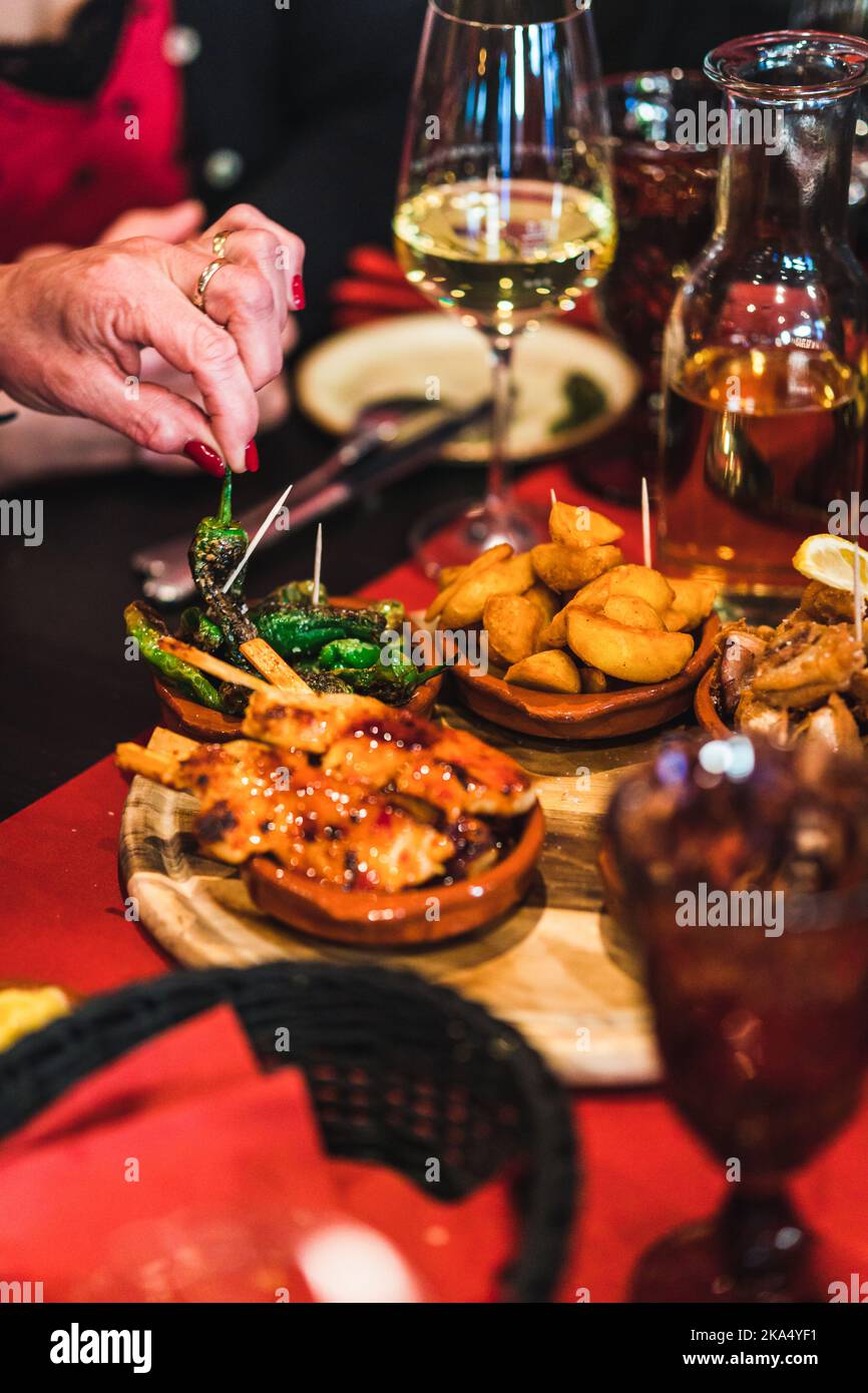 A woman's hand reaching out for some tapas in a tapas bar Stock Photo ...
