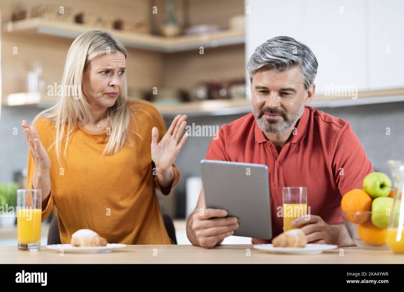 Angry wife fighting with her husband using digital tablet Stock Photo ...
