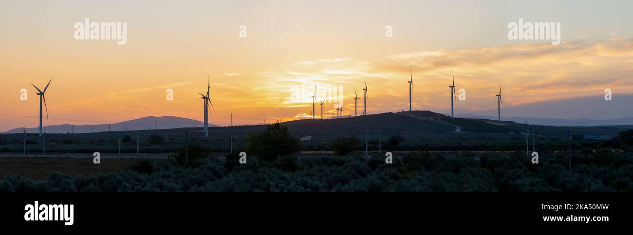 Close up photo of wind turbine and clouds at sunset. Clean energy ...
