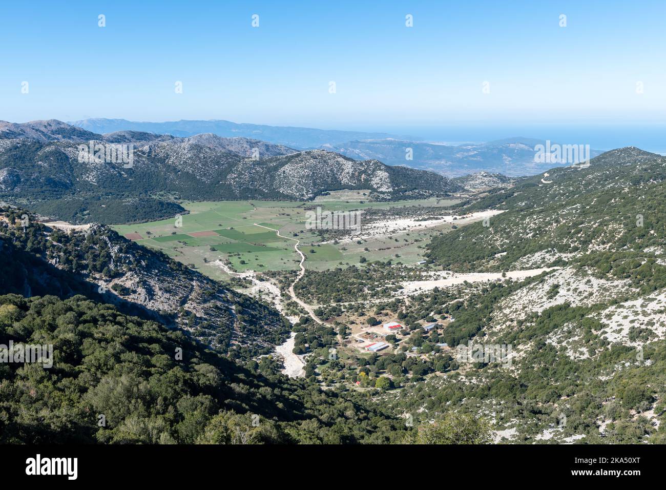 A mountain top view of the landscape below with a panoramic view to ...