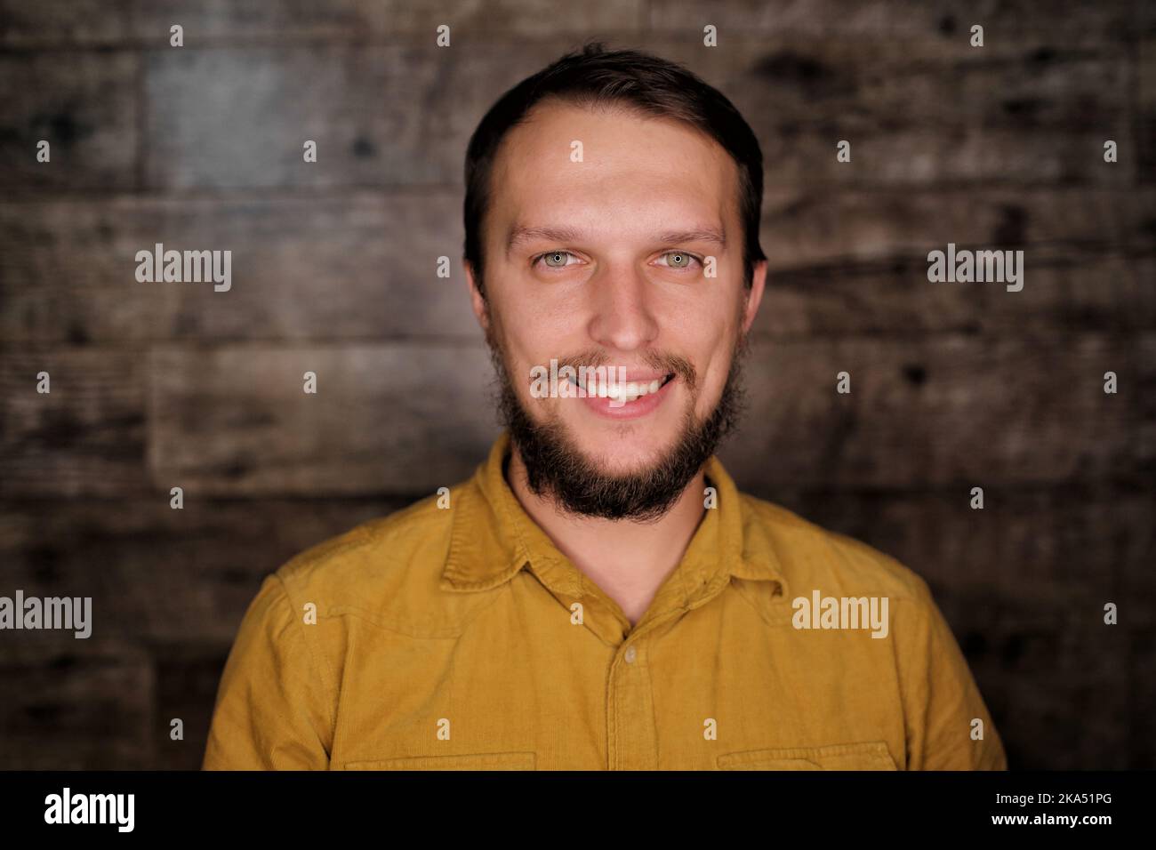 Portrait of handsome bearded man with white toothy smiling looking in ...