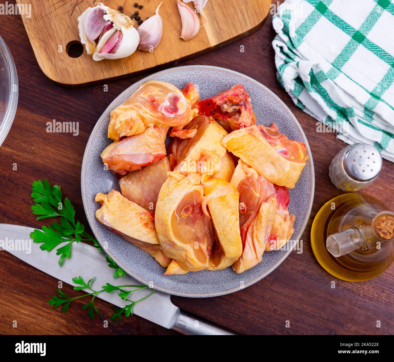 Pieces of unprepared chicken on table Stock Photo - Alamy