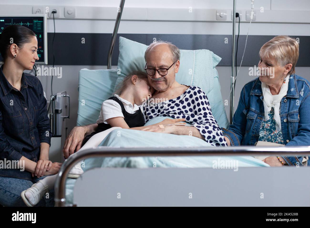 Little girl hugging grandfather at sanatorium room before surgery in ...