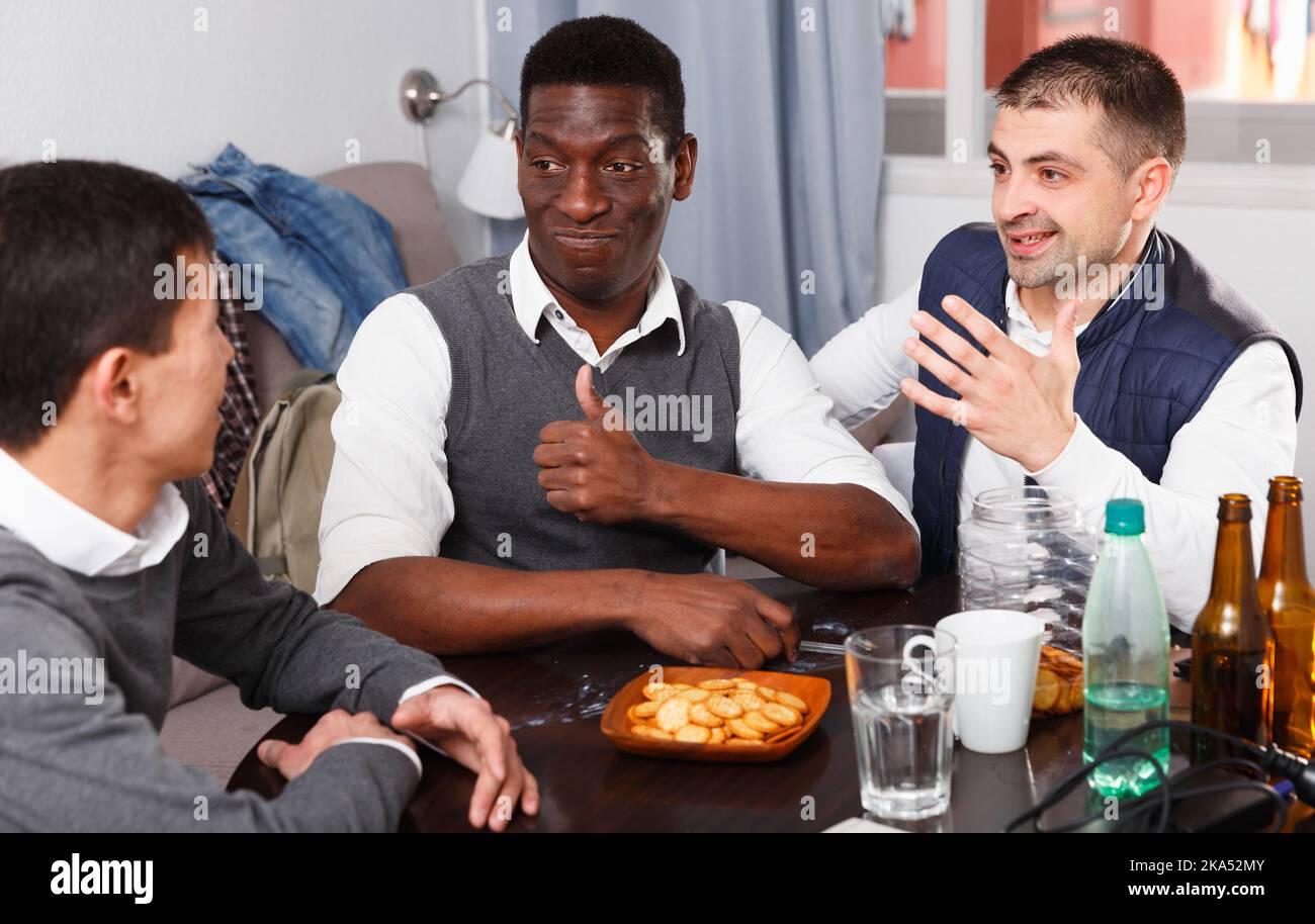 Three friends are talking about life together Stock Photo - Alamy