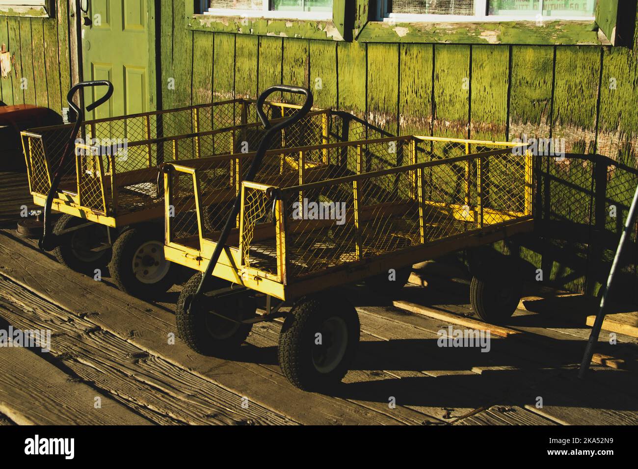 metal wire carts parked next to the outside wall, and wood boardwalk ...