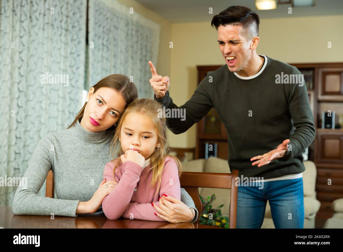 Upset girl and mother with angry father Stock Photo - Alamy