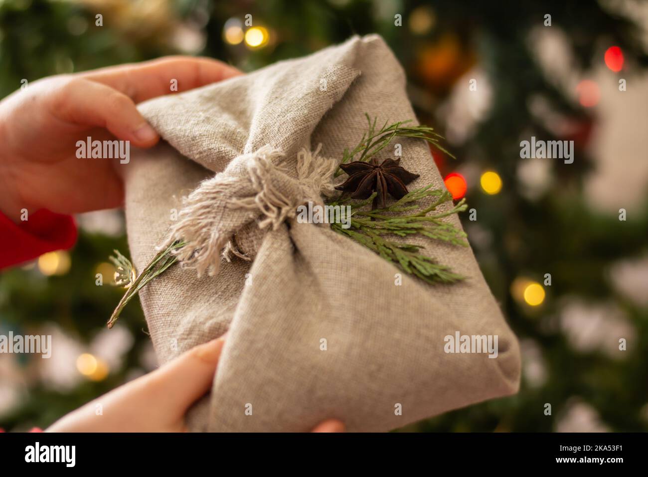 Furoshiki made from natural linen. Children's hands hold eco-friendly ...