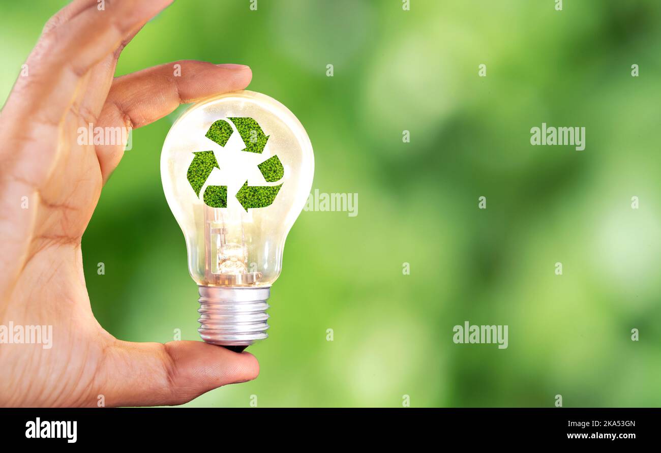 Close up photo of lightbulb with recycle icon with nature background as ...