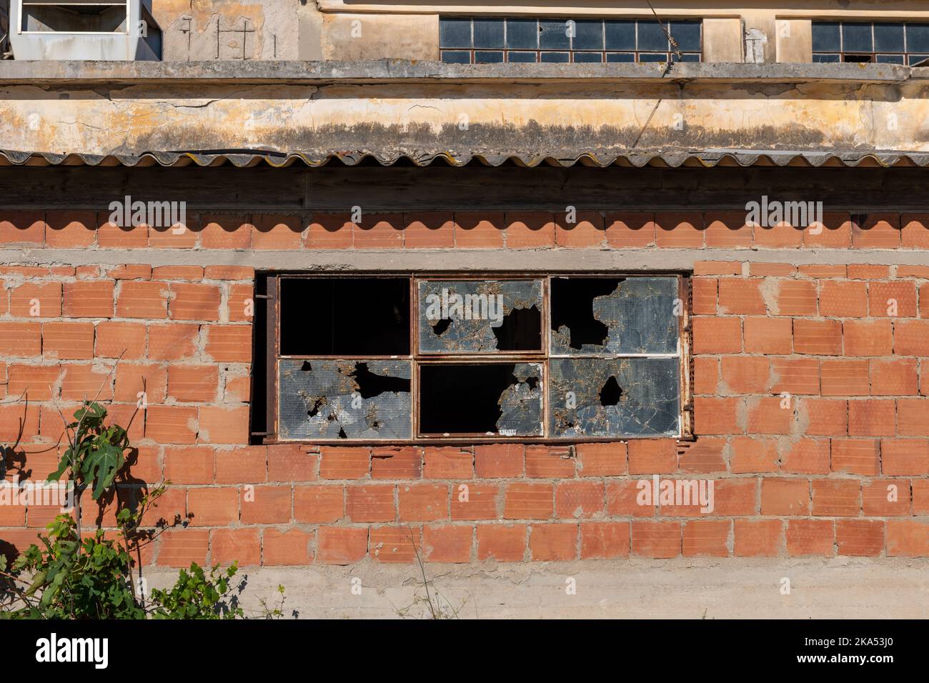 The broken windows of a derelict factory building Stock Photo - Alamy
