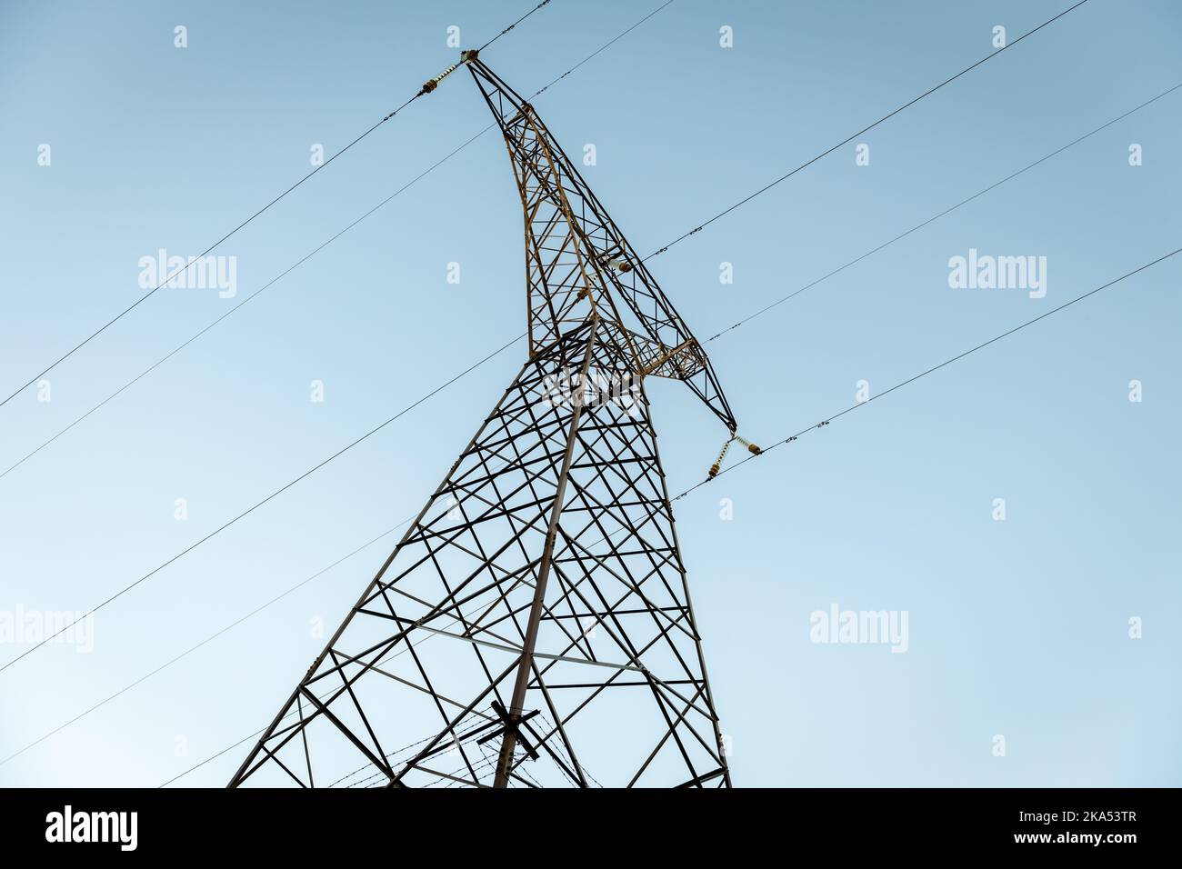 A view of a electricity transmission tower from the base looking upward ...